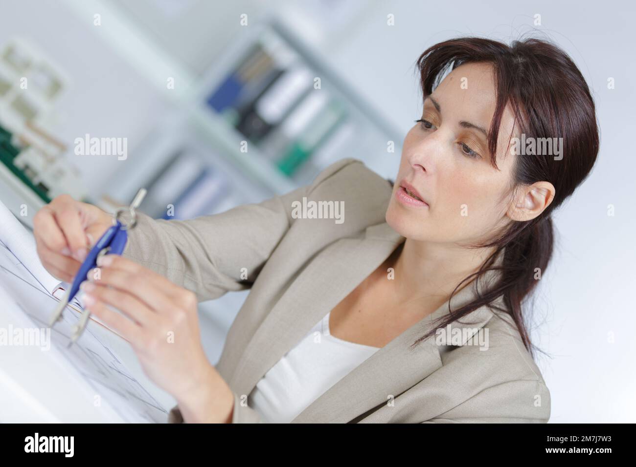 female drawing blueprints using rulers compasses and pencils Stock ...