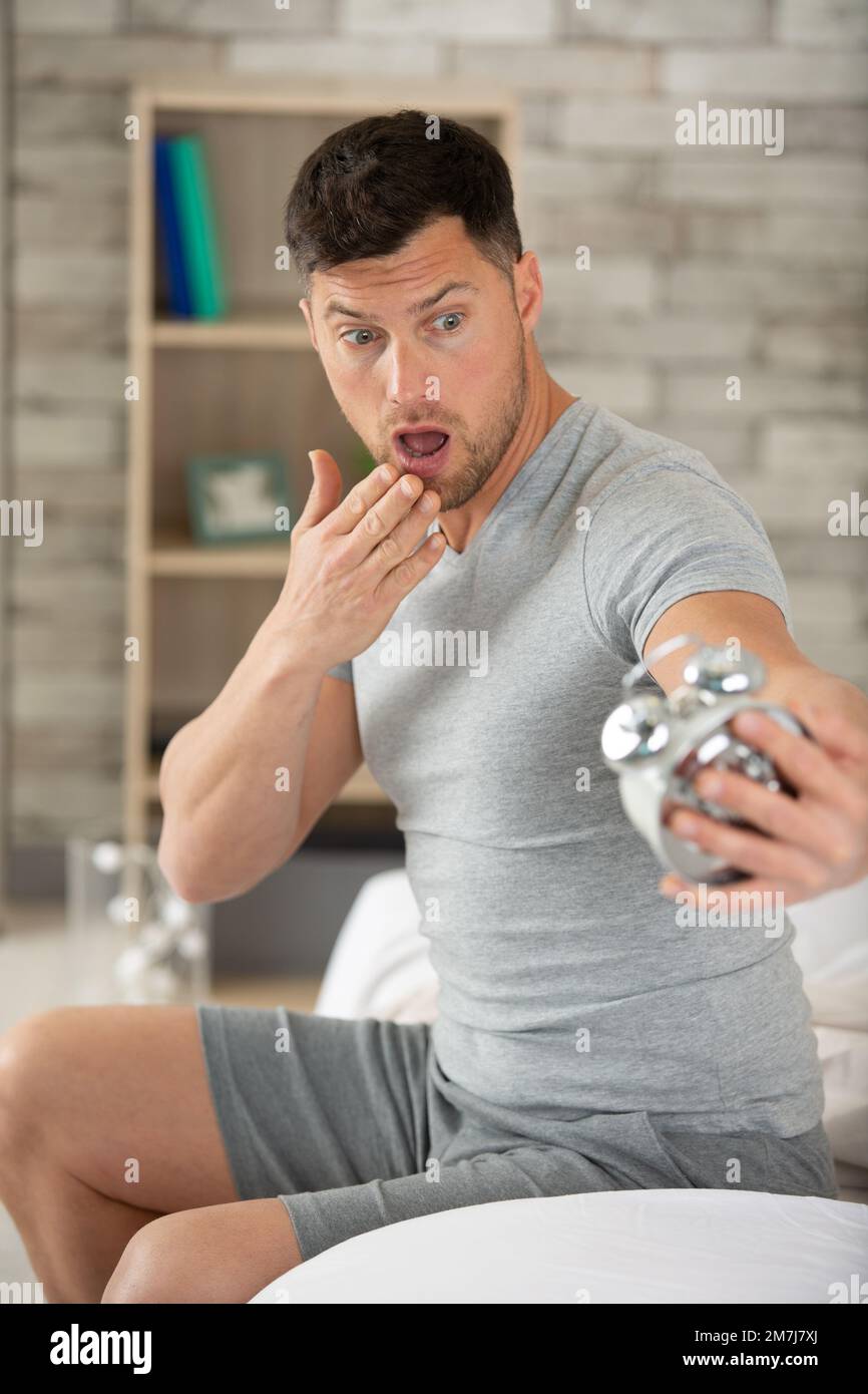 worried man on the bed running out of time Stock Photo - Alamy