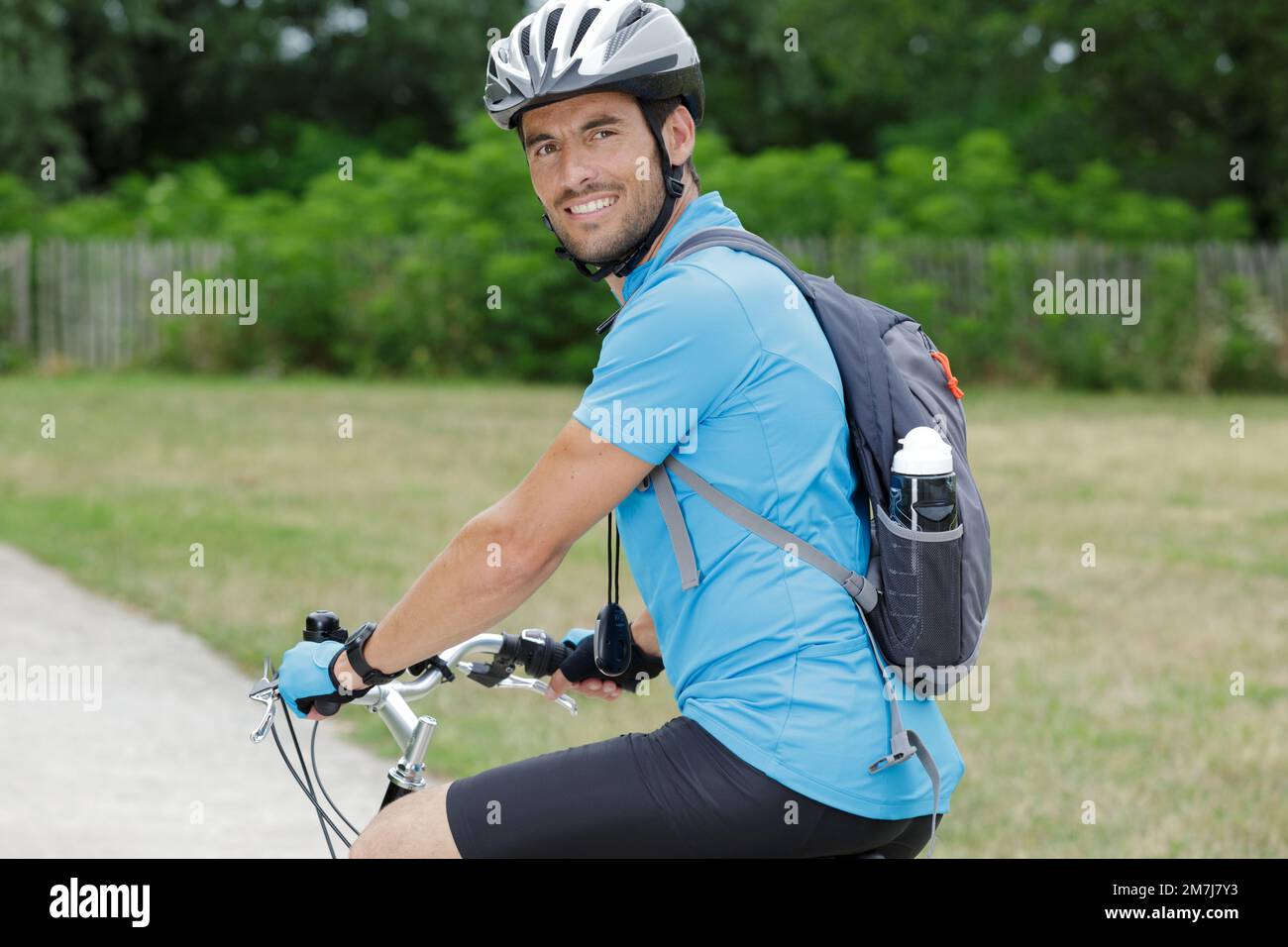 man commuting on bicycle through park Stock Photo - Alamy