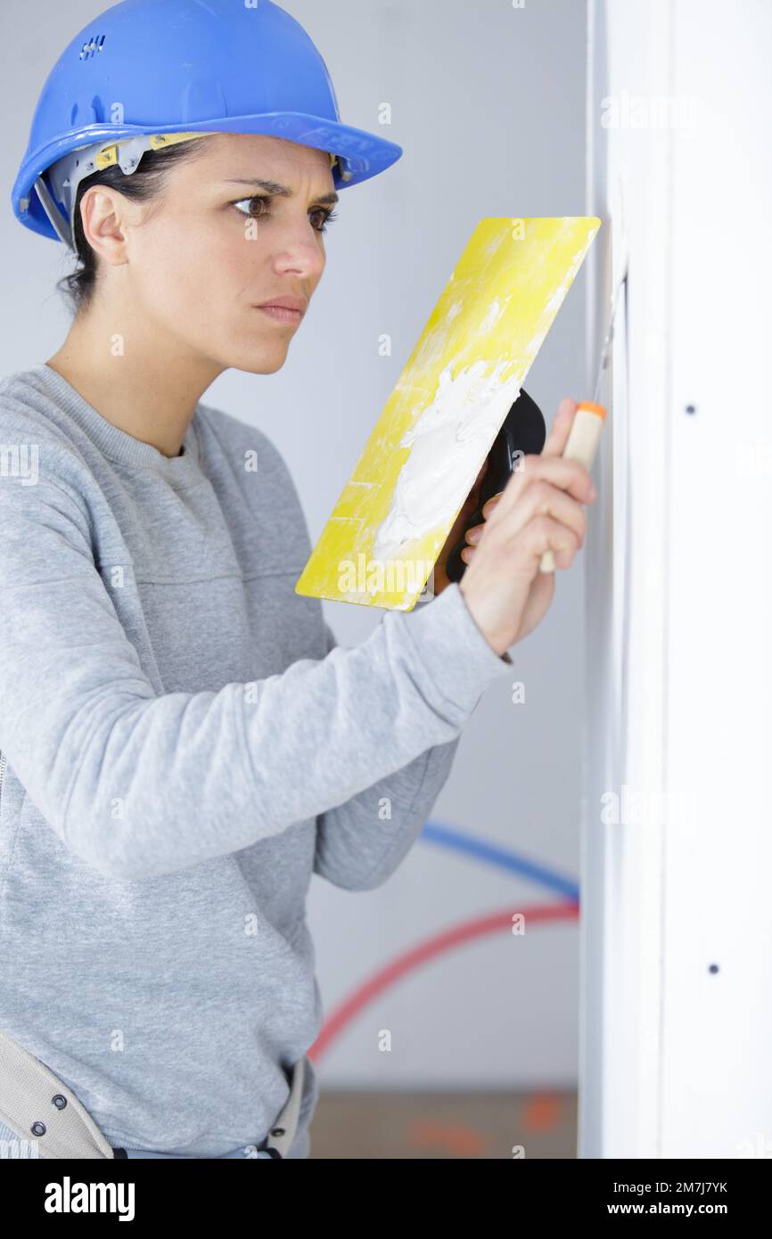 working woman plastering walls inside the house Stock Photo - Alamy