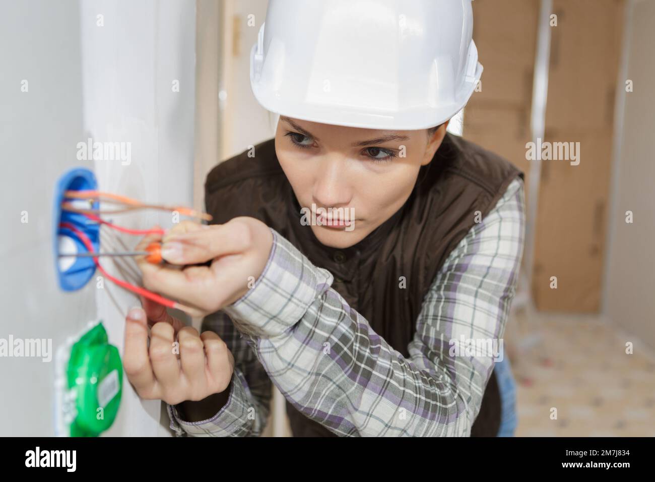 Female electrician fixing socket hi-res stock photography and images ...