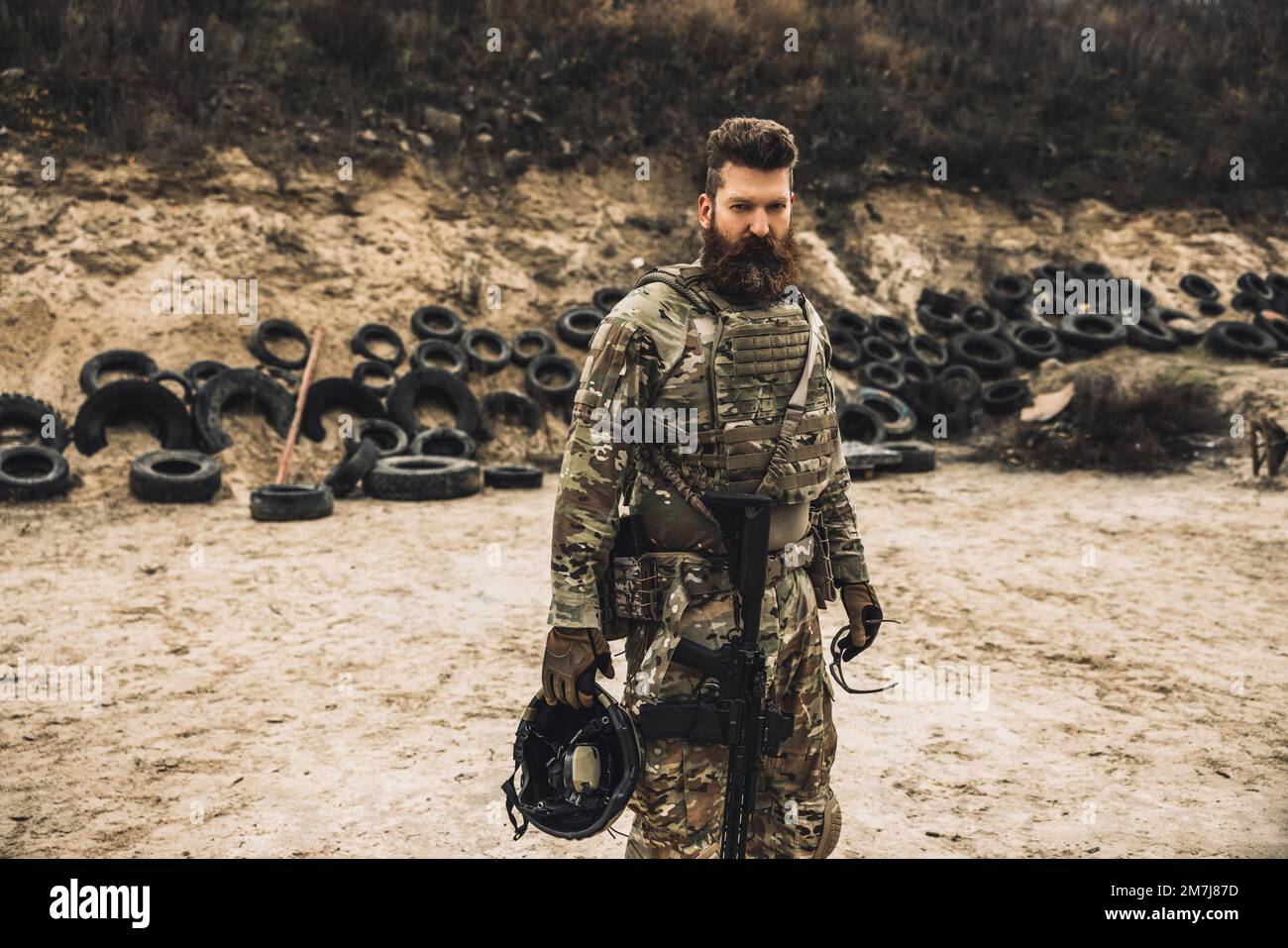 Dark-haired bearded man in military uniform looking determined Stock ...