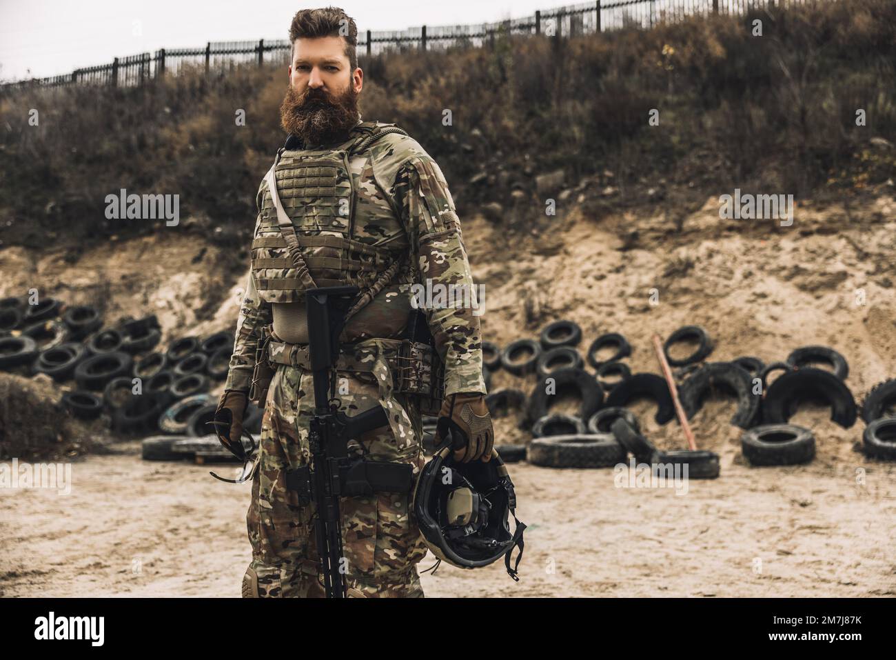 Dark-haired bearded man in military uniform looking determined Stock ...