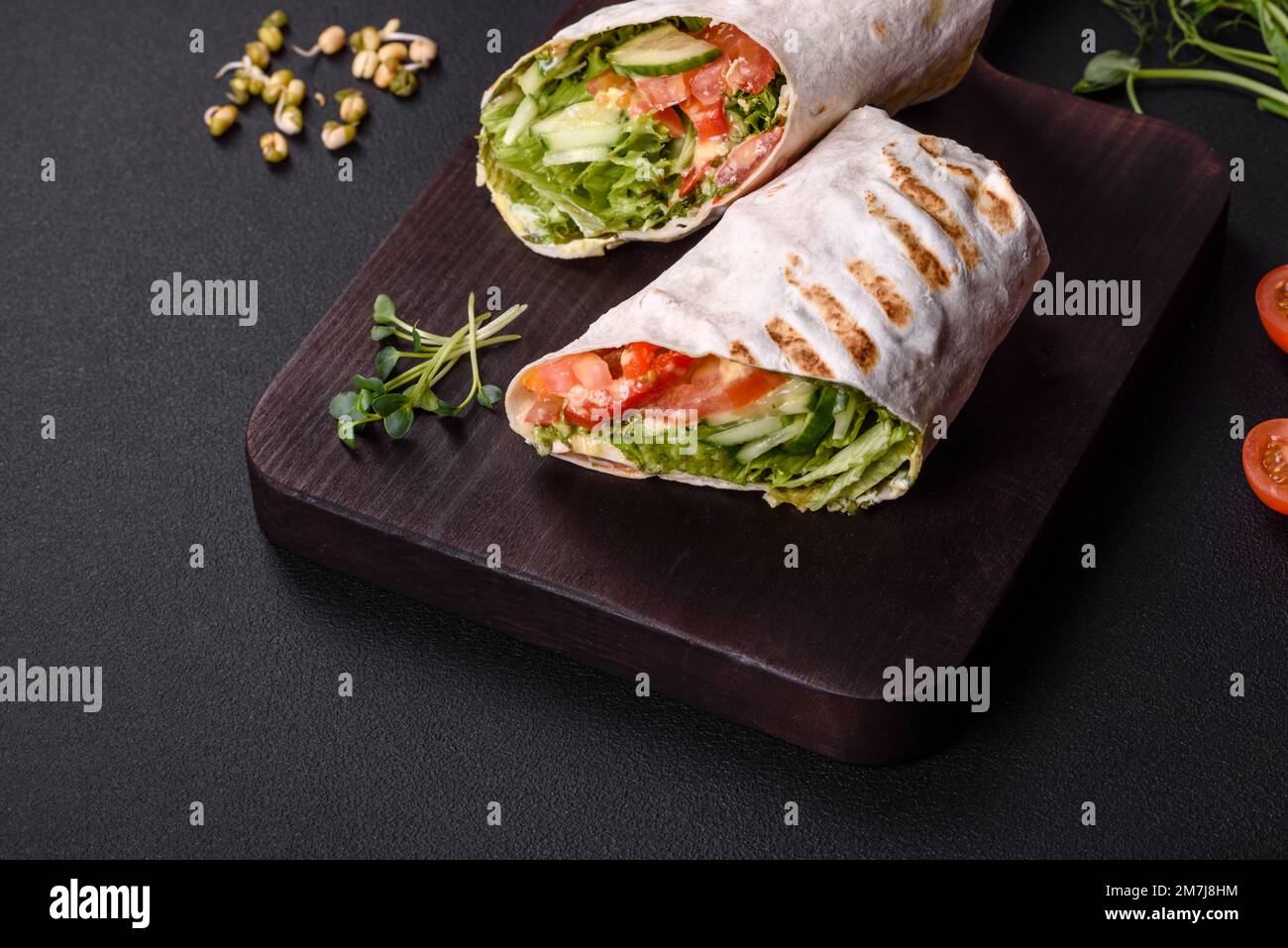 Delicious fresh shawarma with tomatoes, peppers, cucumber and sauces on ...