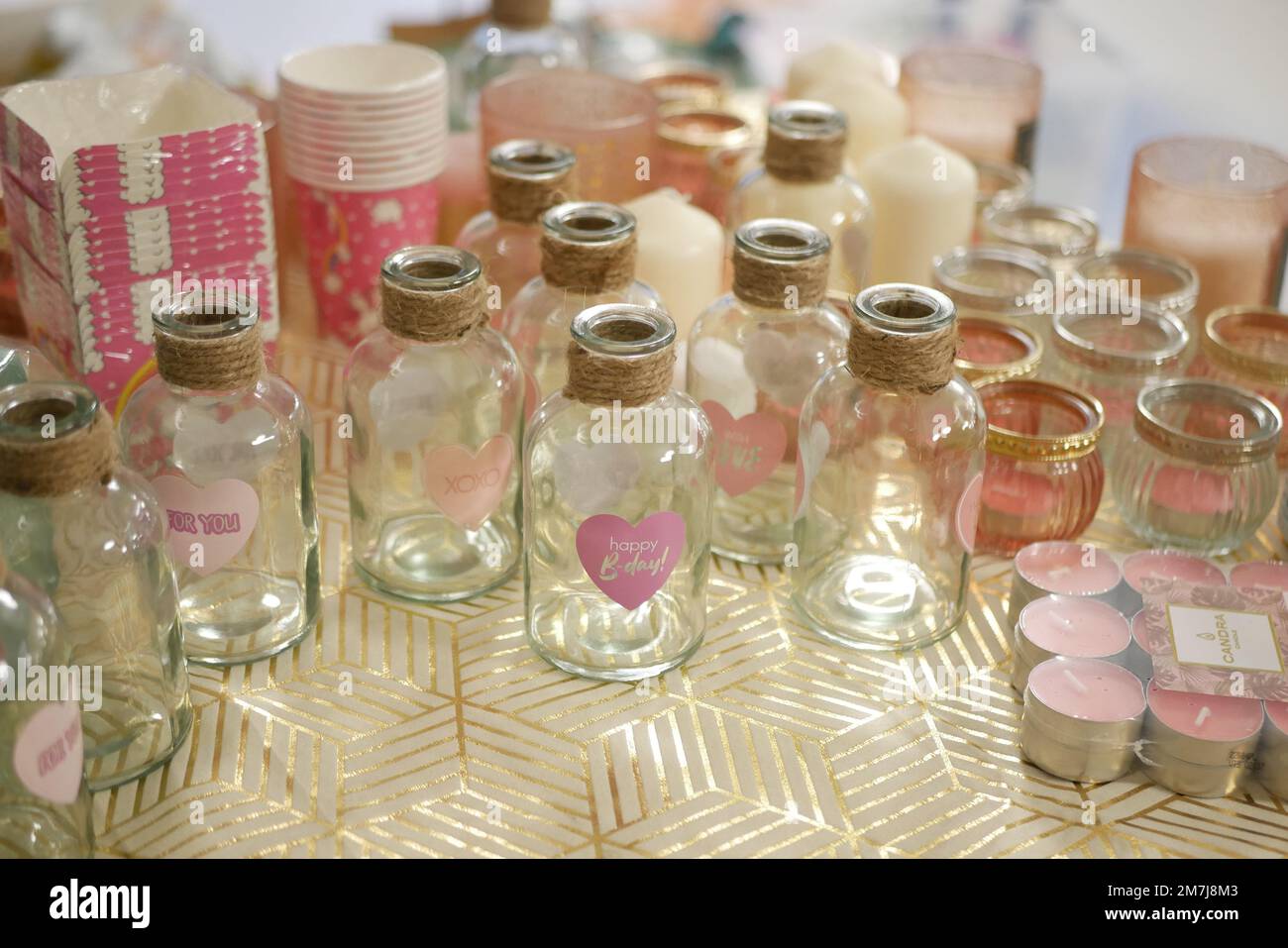 A table with lots of candles and glass vases Stock Photo - Alamy