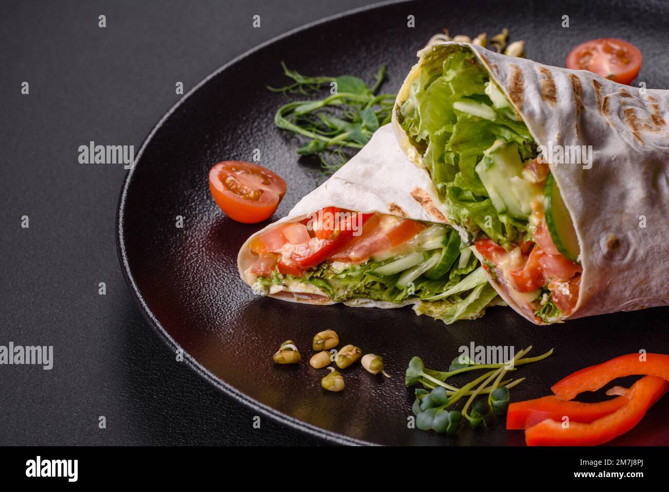 Delicious fresh shawarma with tomatoes, peppers, cucumber and sauces on ...
