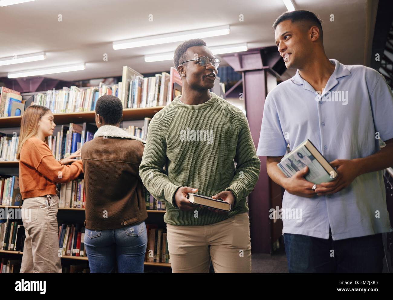 Education, students or friends in library at university, college or ...