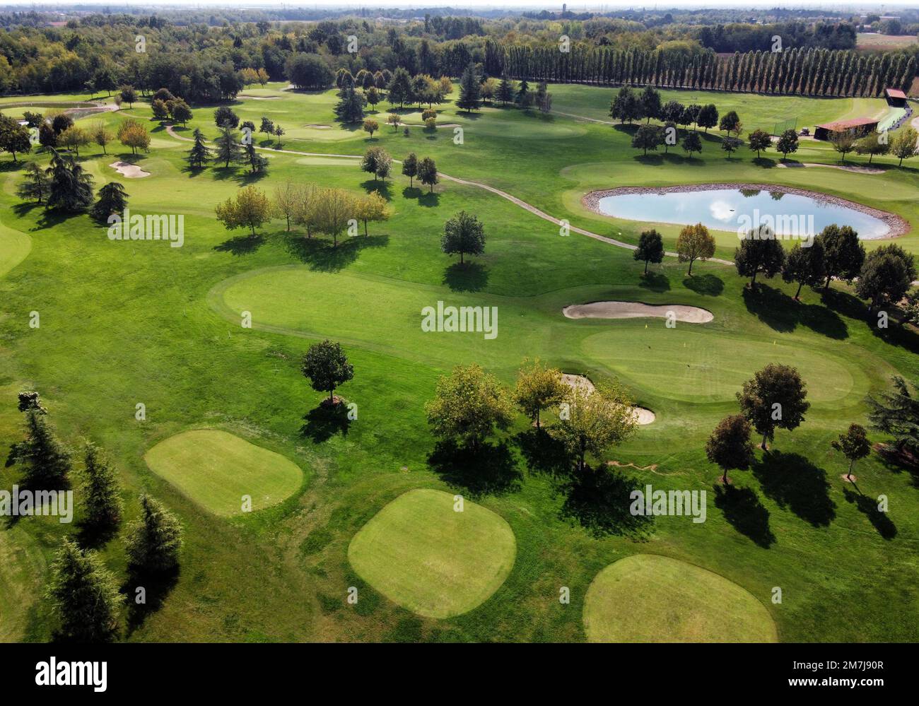 Aerial landscape of course of golf with green grassy meadows and ponds ...