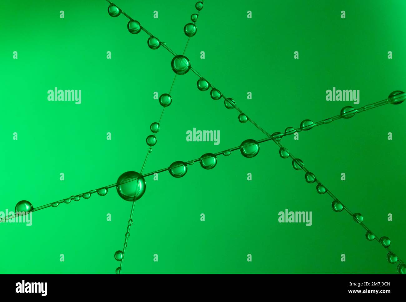 Water droplets on a fine web refracting coloured light Stock Photo - Alamy