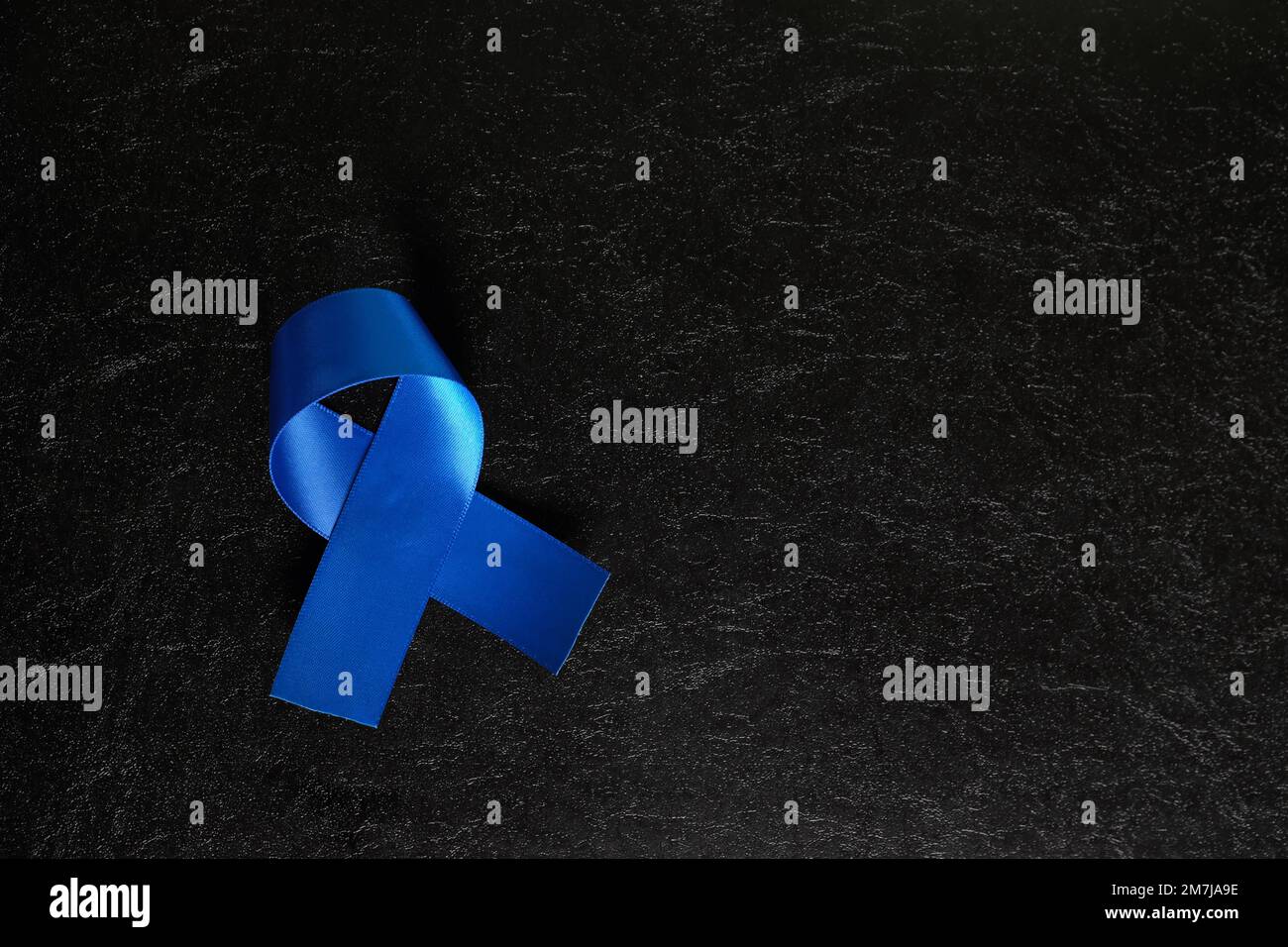 Dark blue ribbon color isolated on dark black background. Colon and ...