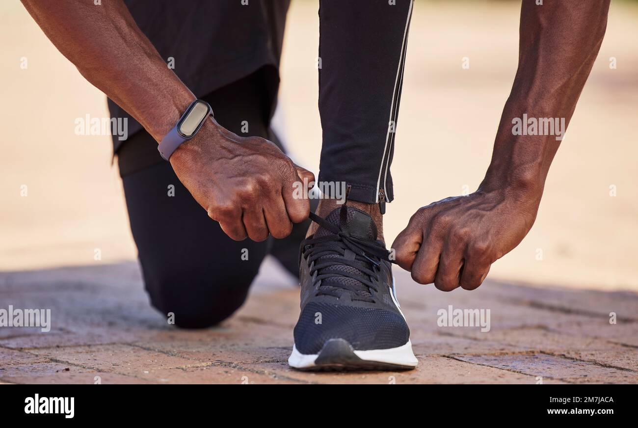 Workout shoes, running and black man runner with fitness outdoor, hands ...
