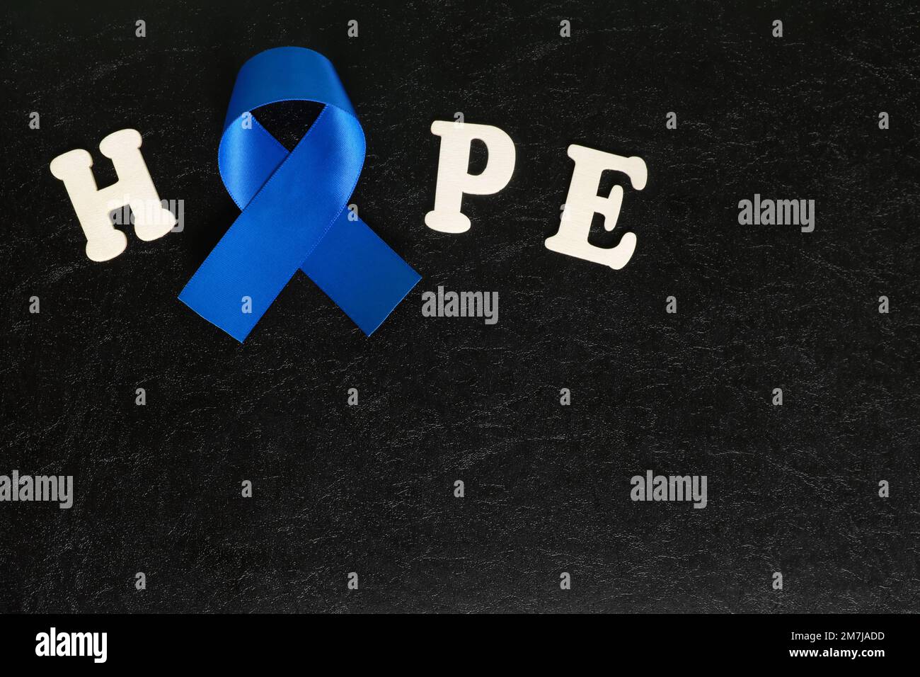 Dark blue ribbon color isolated on dark black background. Colon and ...