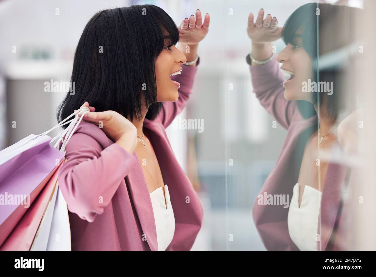 Excited woman, window shopping and mall for retail therapy, sale or ...