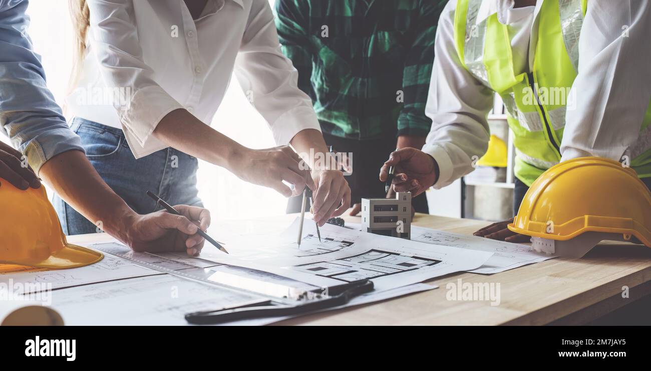 Architect team working with blueprints for architectural plan, engineer ...