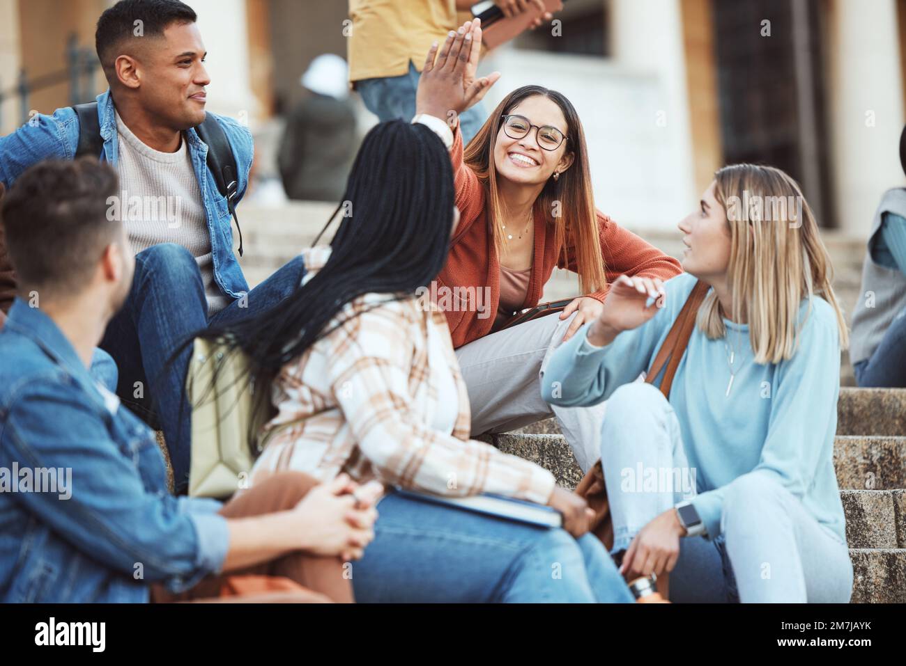 Talking, students or high five on university stairs, college campus ...