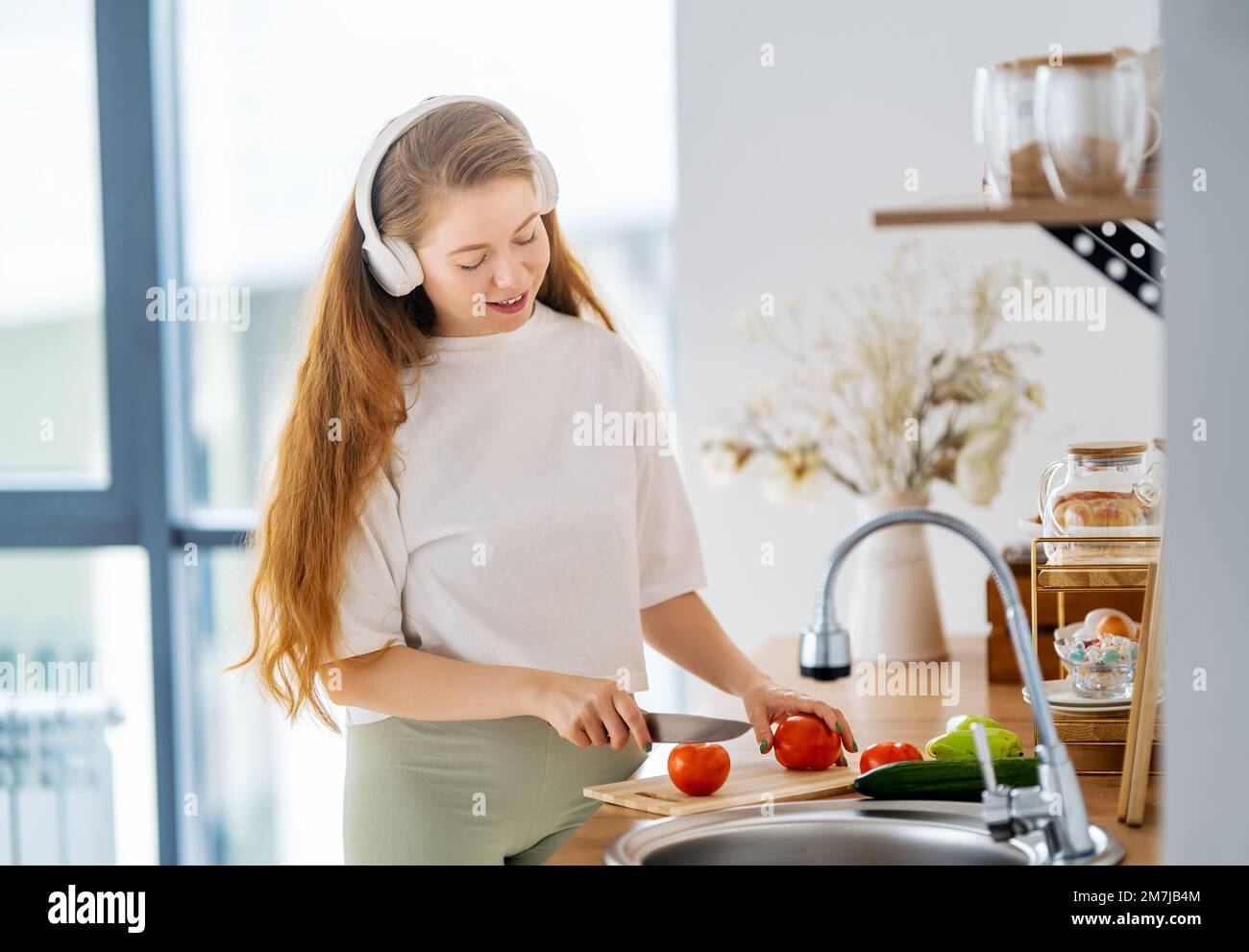 Healthy food at home. Woman is preparing the proper meal in the kitchen ...