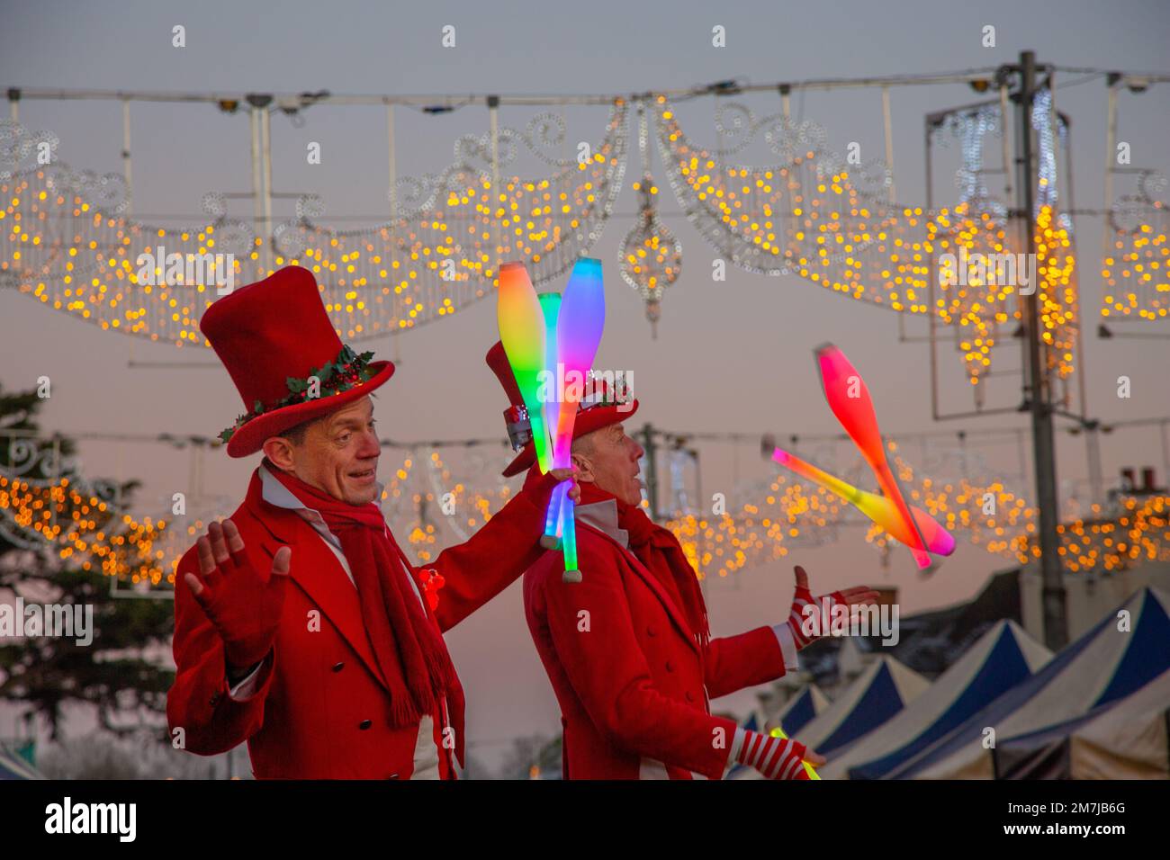Street performer's stilt walking jugglers at the Stratford on Avon Christmas Street market ...
