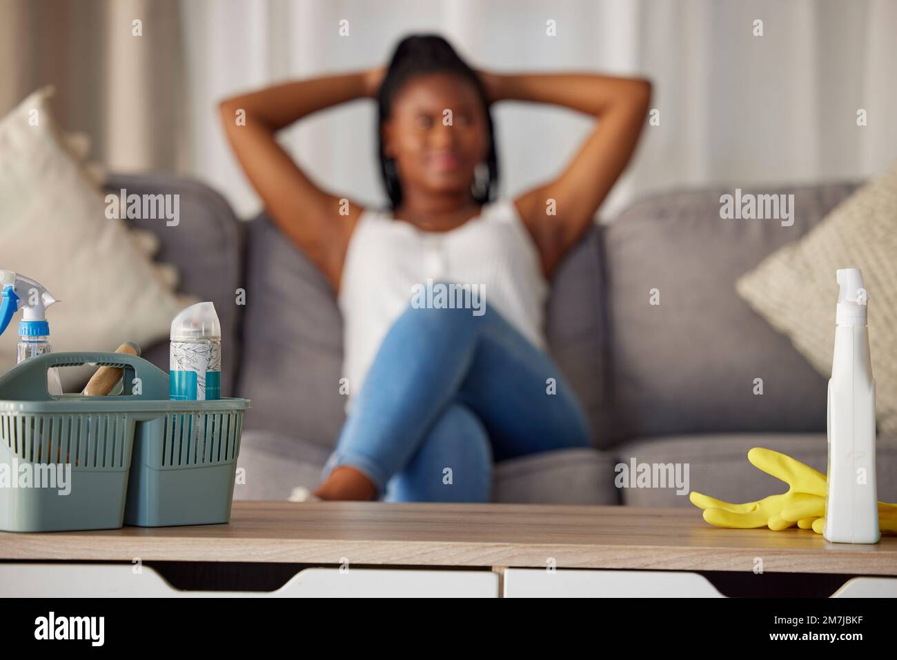 Happy, relax and black woman on the sofa after cleaning, housework ...