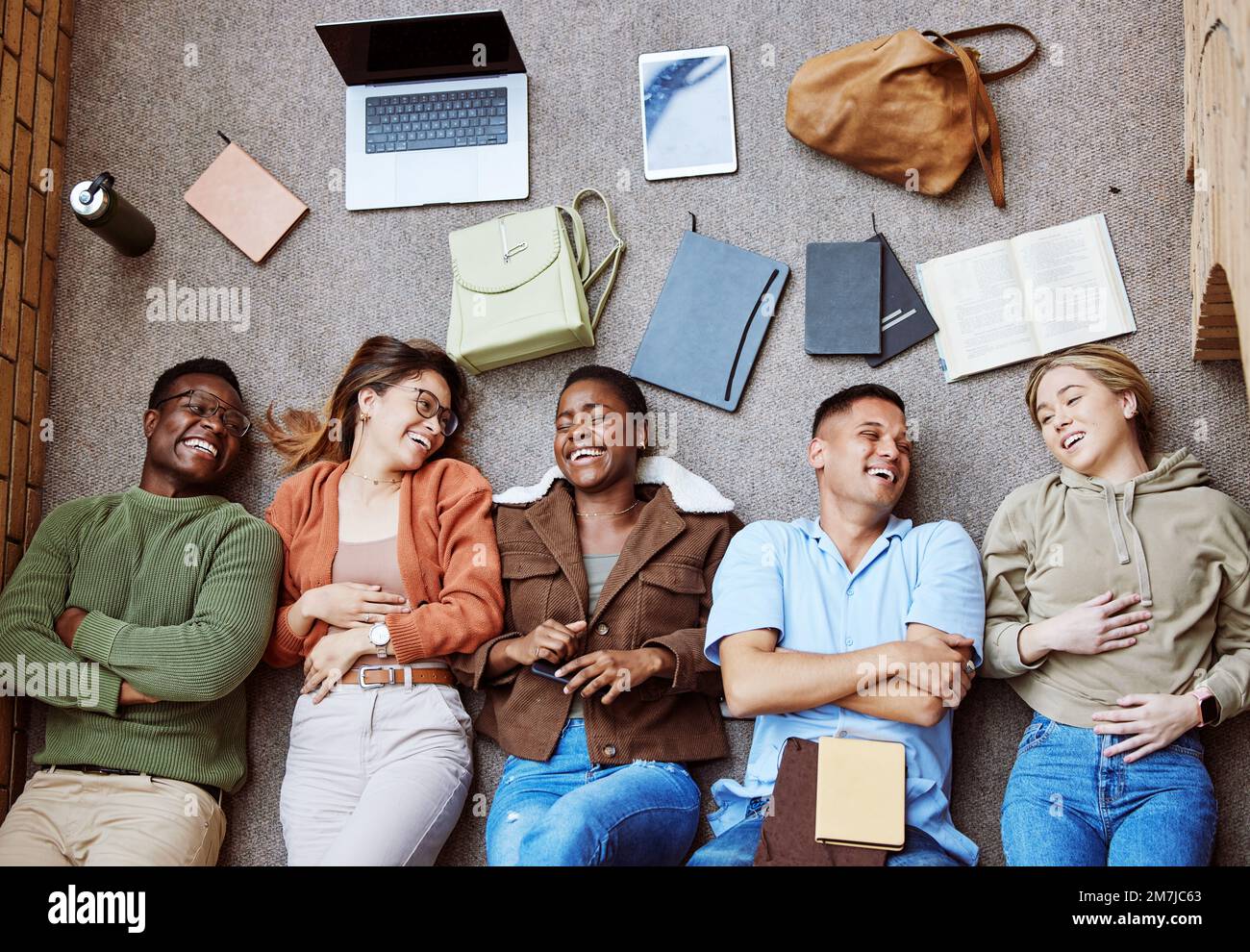 College floor, diversity and laughing students relax after group project, research education ...