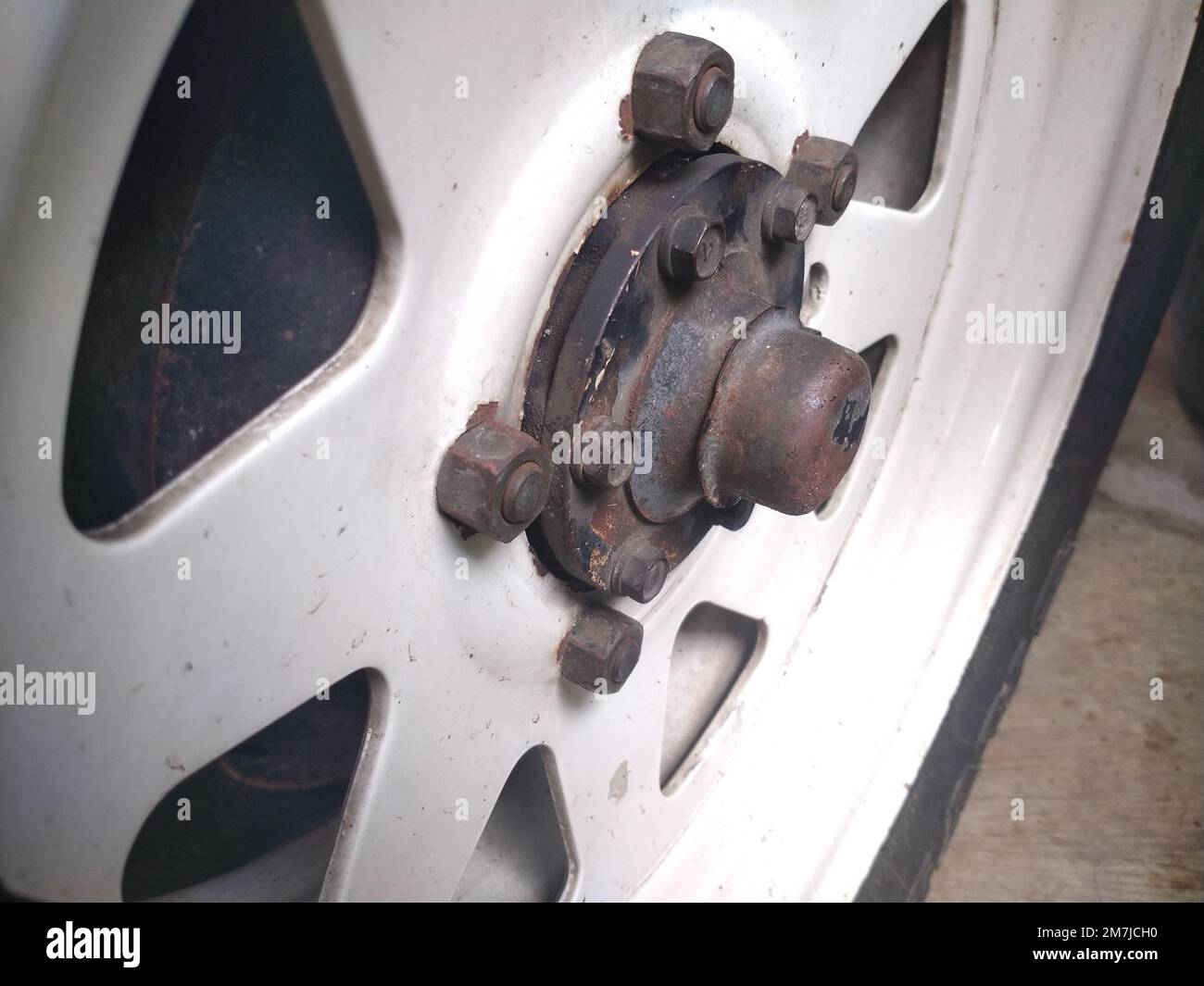 photo of a white car rim close up, parked car. High angle shot, wheel ...