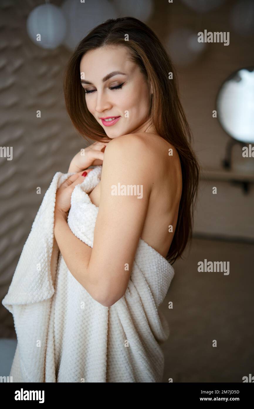 Soft focus portrait of cute woman with closed eyes wrapped in towel after bath Stock Photo - Alamy