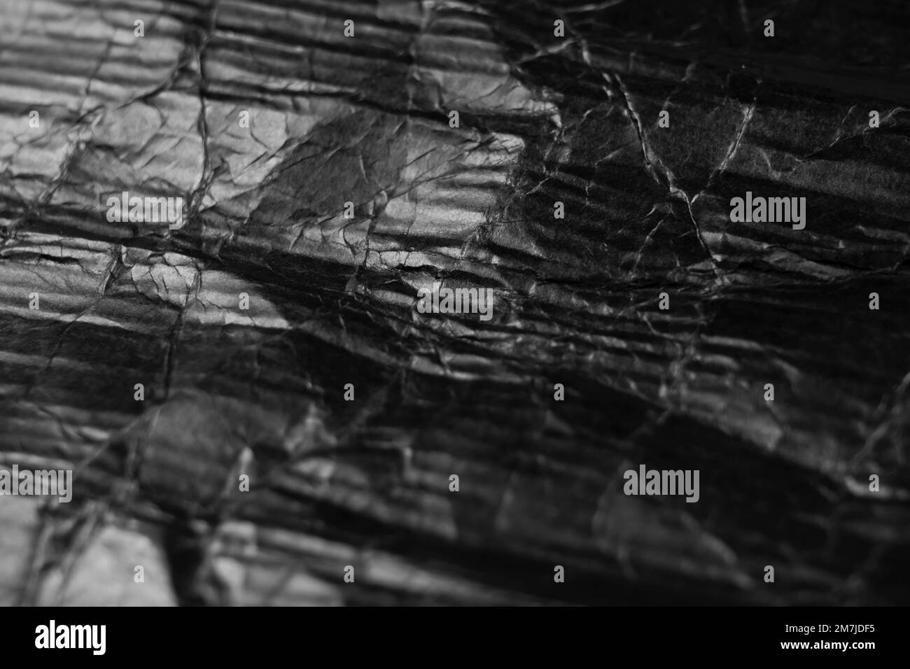 Crumpled wrinkled black paper. Corrugated aged grunge cardboard surface ...