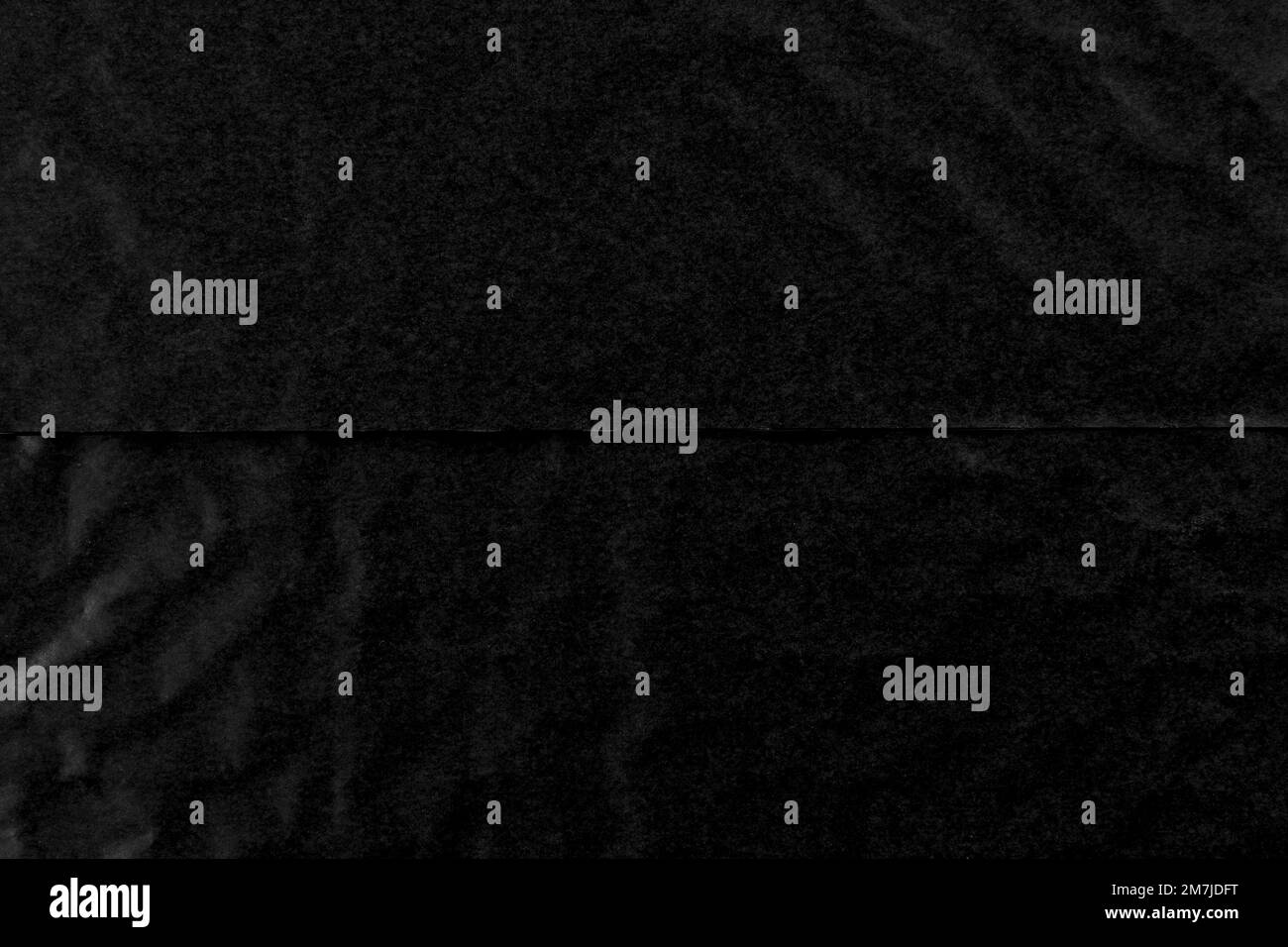 Crumpled black paper background cut in half. Dark abstract layered ...