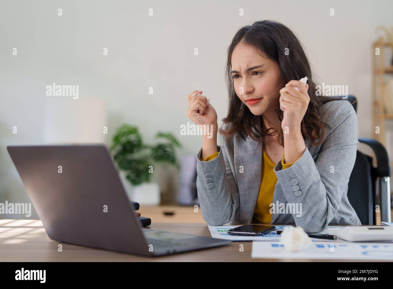 Stressed Asian business woman worry with many document on desk at ...