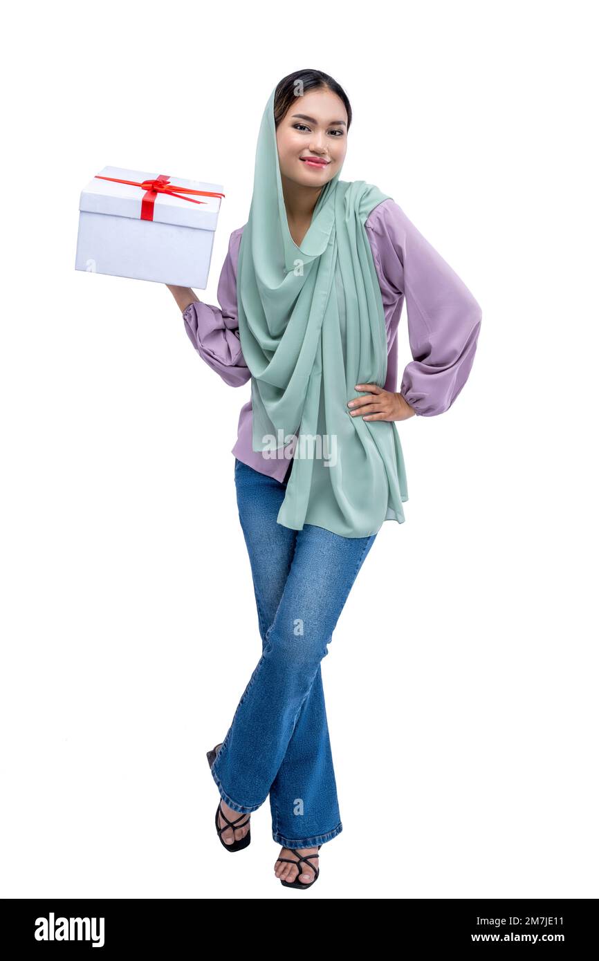 Asian Muslim woman in a headscarf holding a gift box isolated over ...