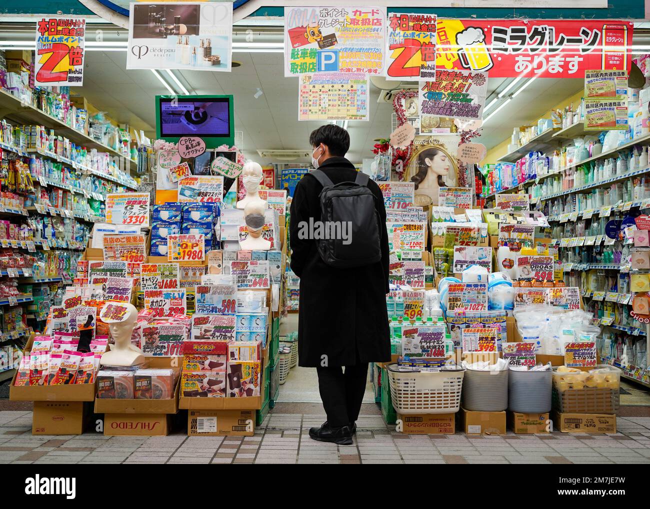 Tokyo, Japan. 10th Jan, 2023. A man looks at products at a drug store ...
