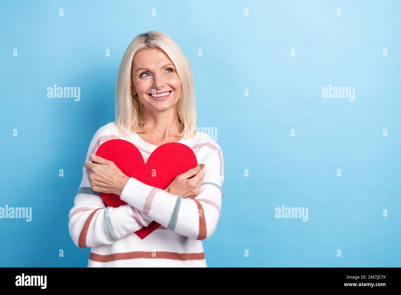 Photo of dreamy stunning senior woman hold hug red paper card ...