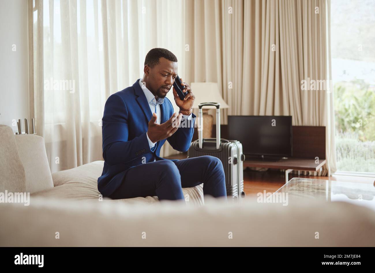 Phone call, travel stress and businessman with a phone for hotel ...