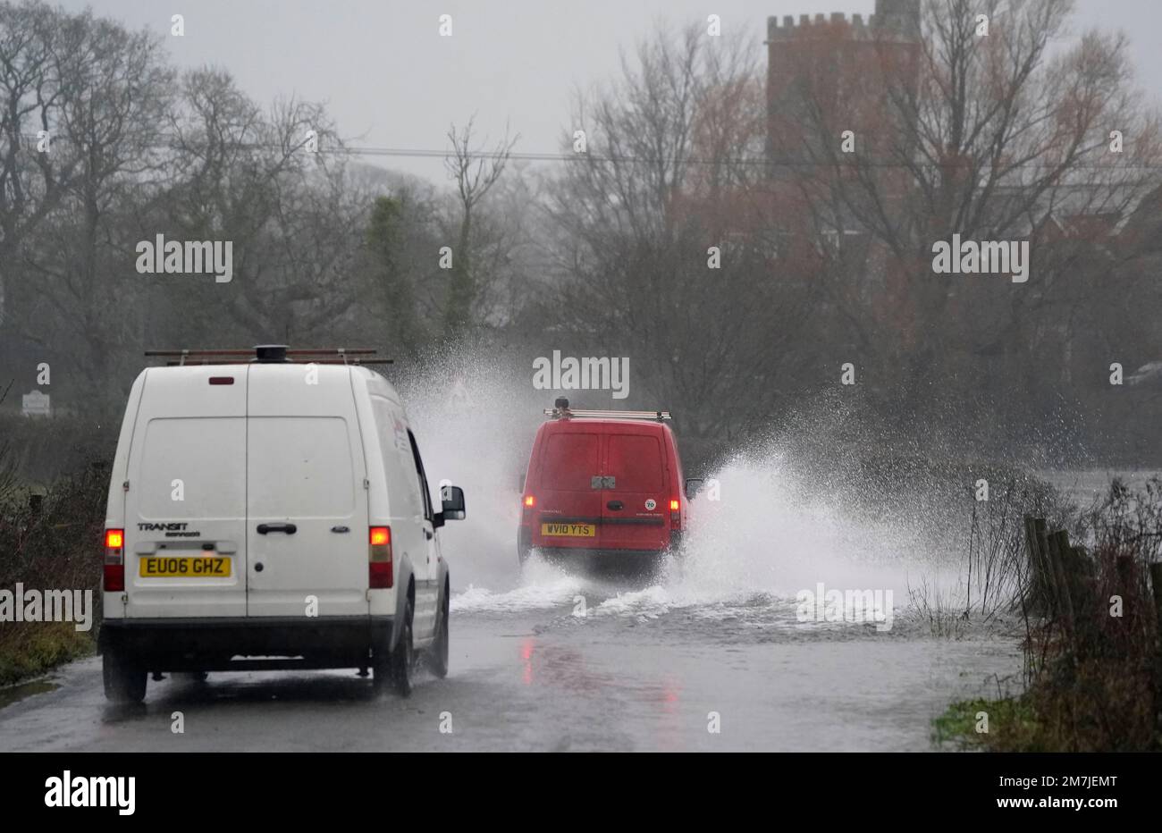 Cars make their way through flood water on Kent Lane, near to Ibsley in ...