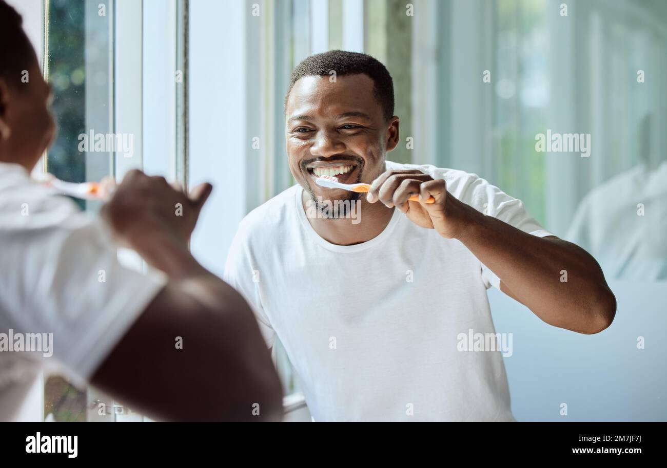 Morning, happy and black man brushing teeth in bathroom for health ...