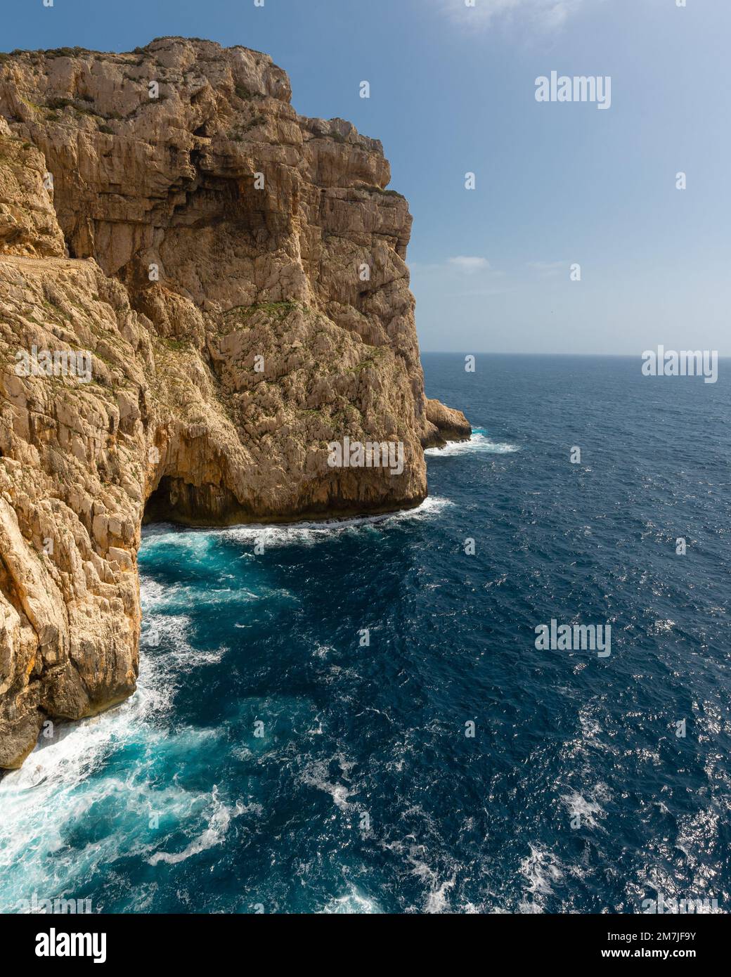 A vertical shot of the cliff with a cave. Neptune's Grotto, Sardinia ...