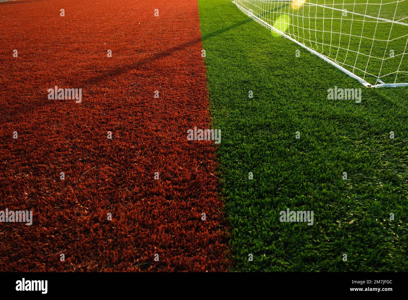 Close up shot of red and green colored artificial grass in a football ...