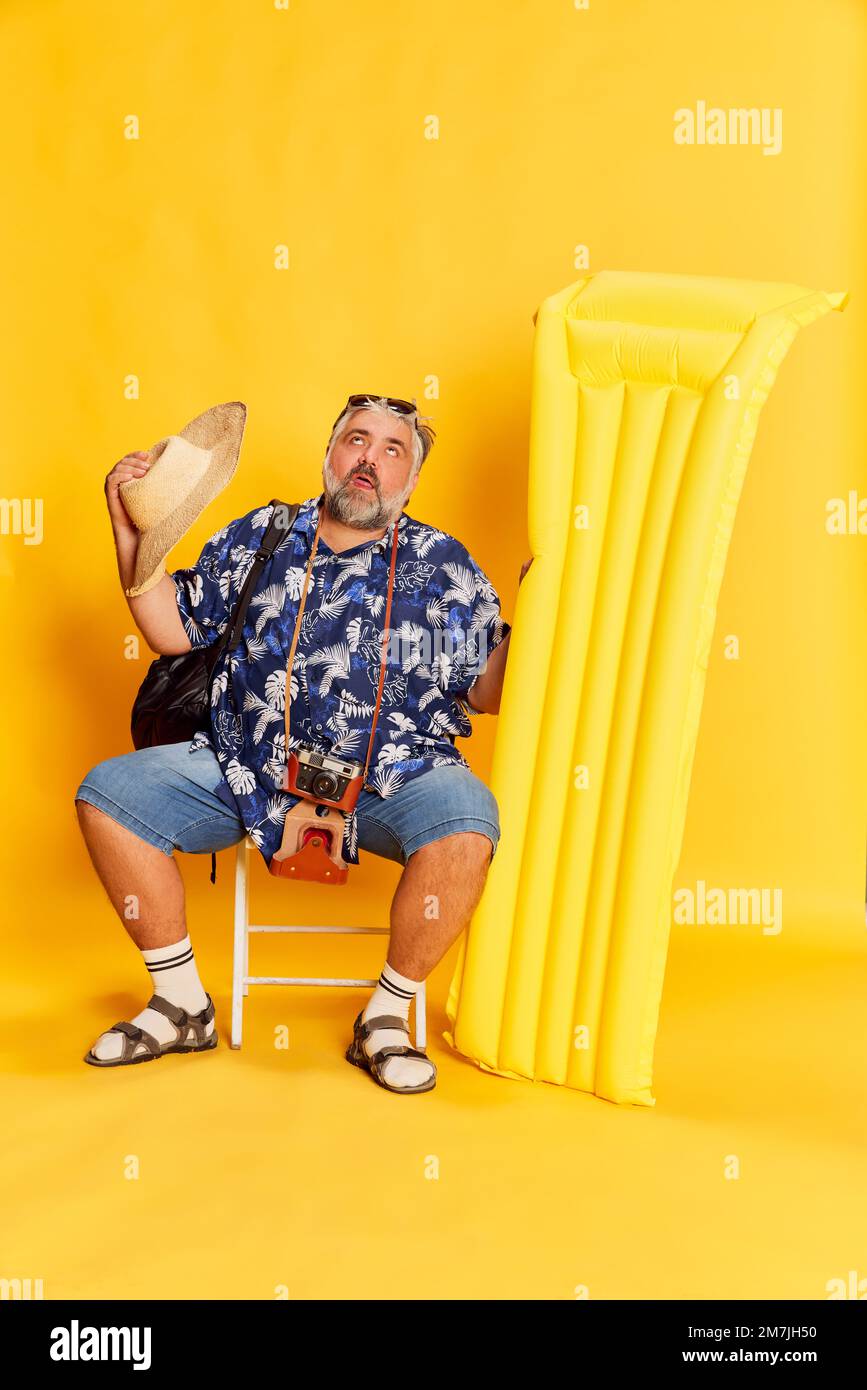 Portrait Of Fat Mature Man In Stylish Shirt Sitting With Swimming