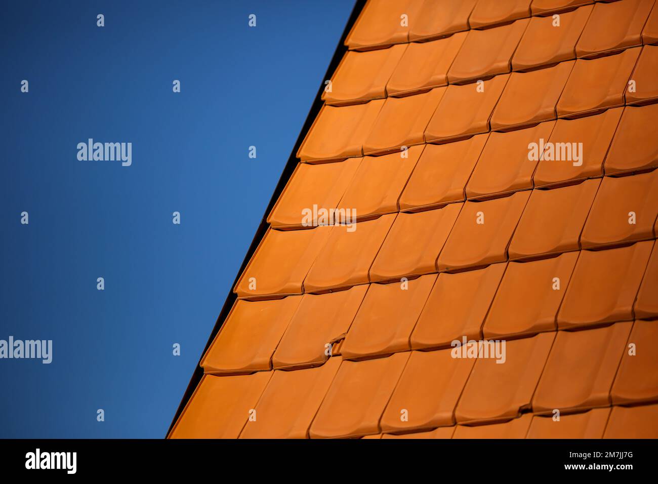 Details of orange brick tile roof patterns with clear bright blue sky ...