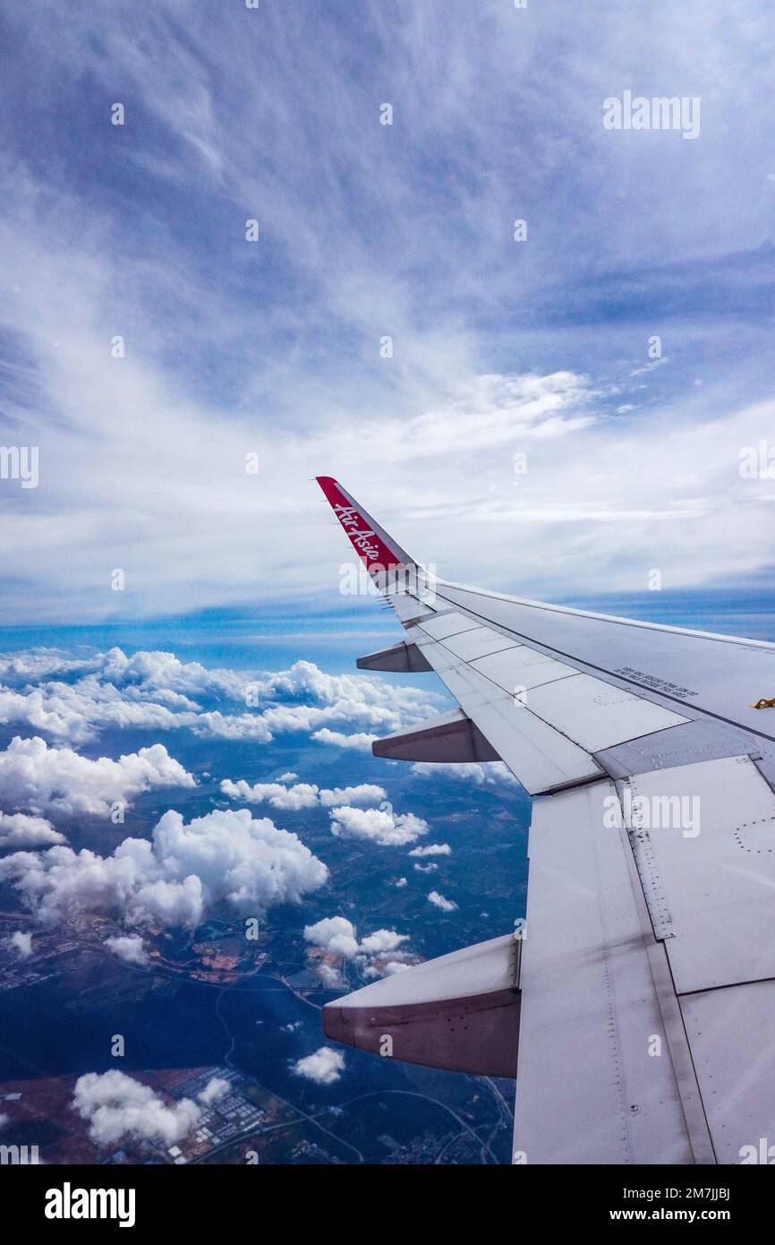 An airplane wing in background of clouds Stock Photo - Alamy