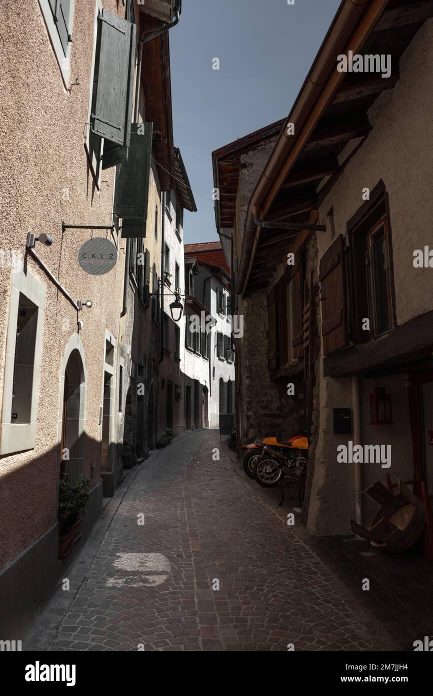 a narrow old street with old buildings on both side Stock Photo - Alamy
