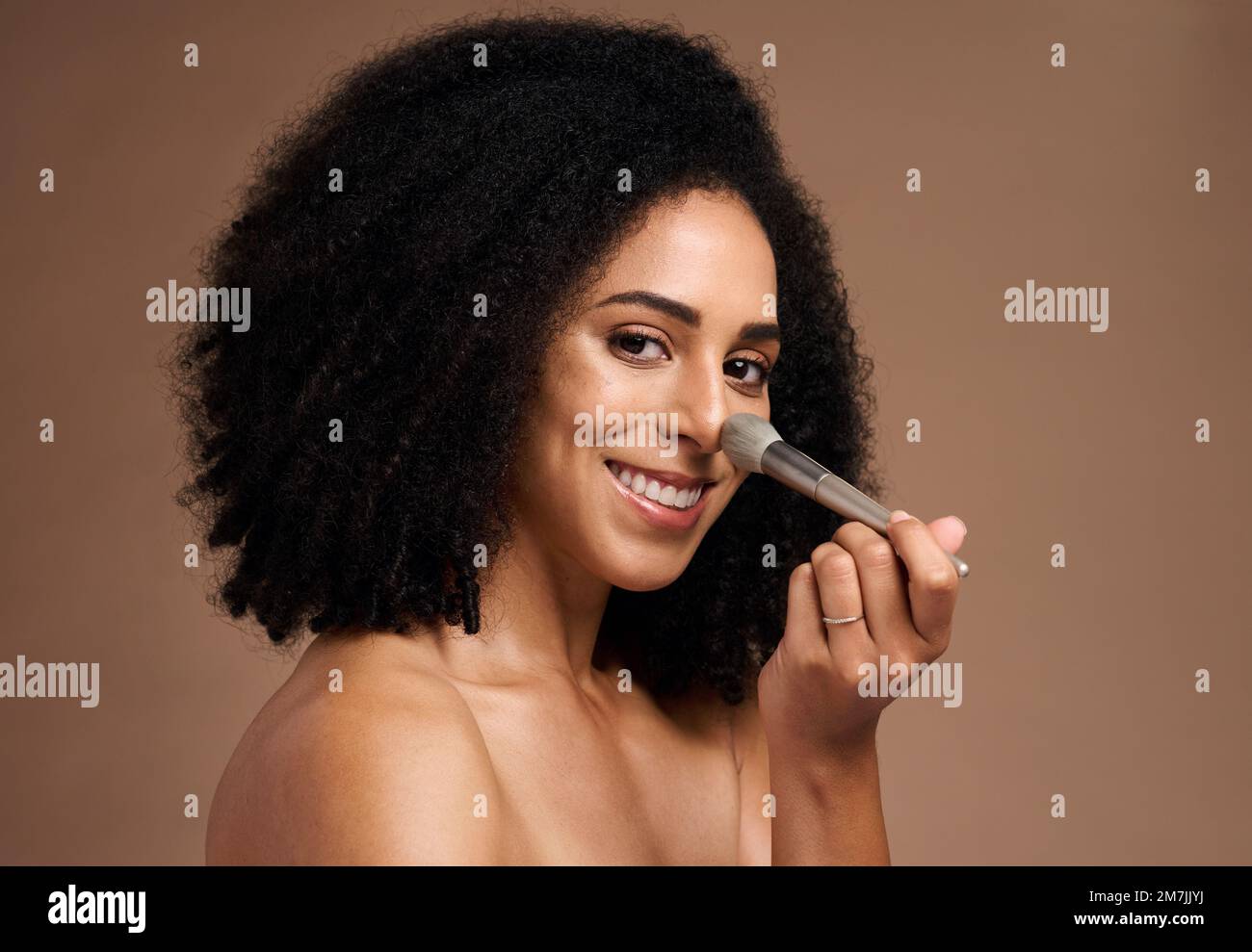 Black woman, studio portrait and brush for foundation, beauty or ...