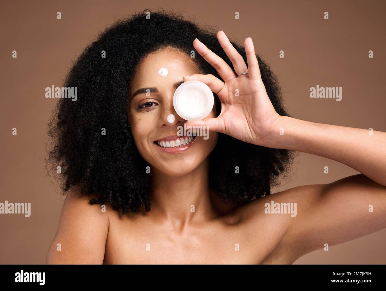 Face, product and skincare with a model black woman in studio on a ...