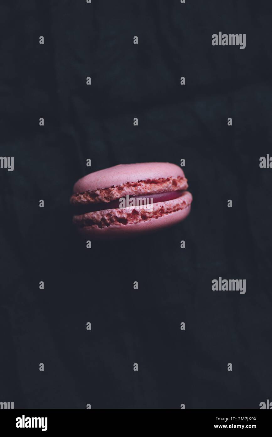 One macaroon on dark background, pink french cookies macaroons Stock ...