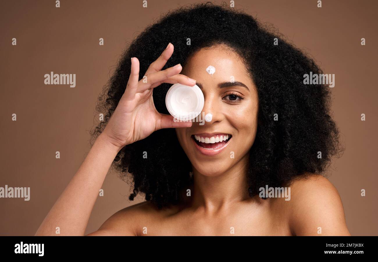 Face, skincare and black woman with cream container in studio on a ...