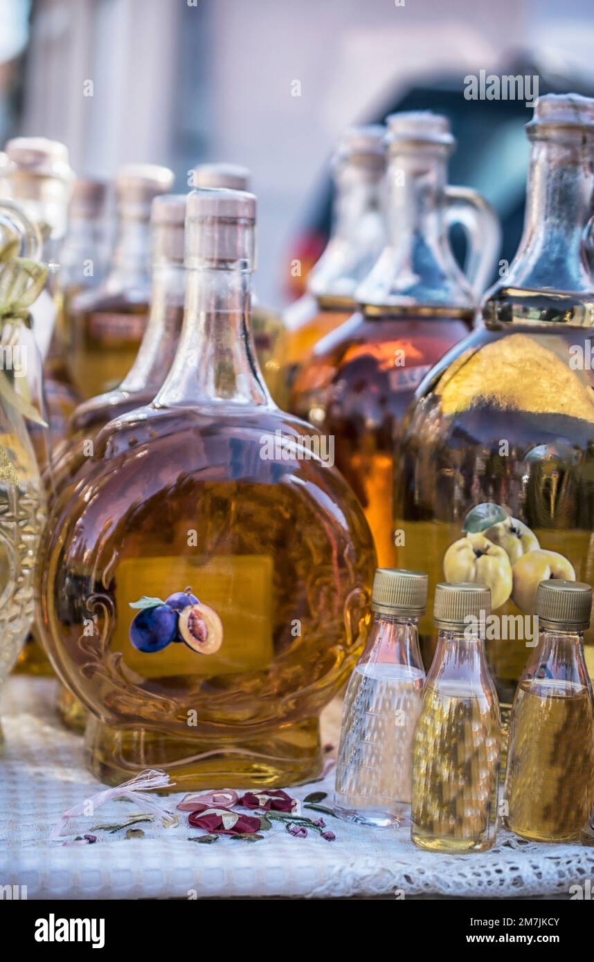 Traditional Balkan brandies in the bottles on the market stall Stock ...