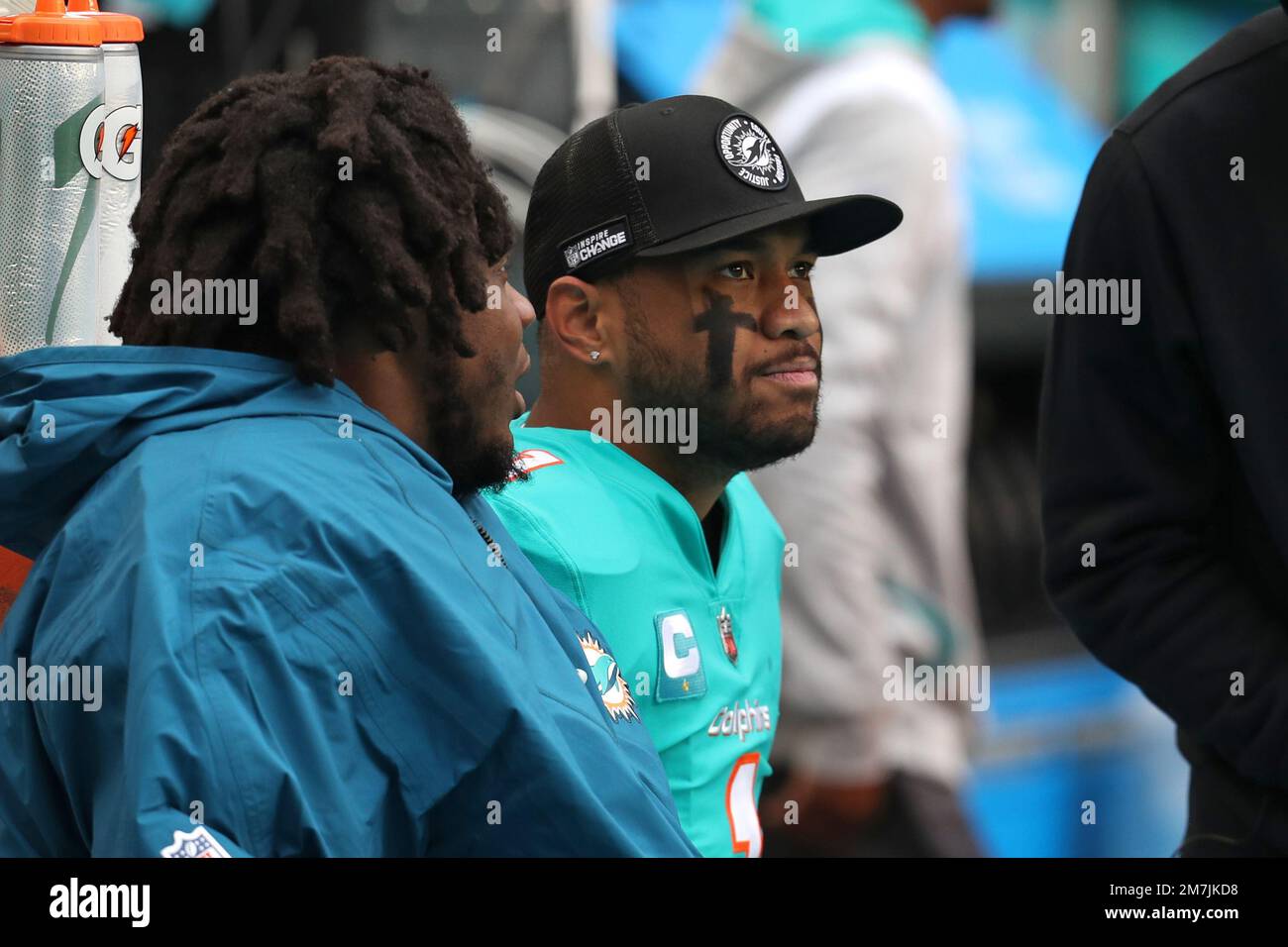Dolphins quarterback Tua Tagovailoa sits on the bench against the ...