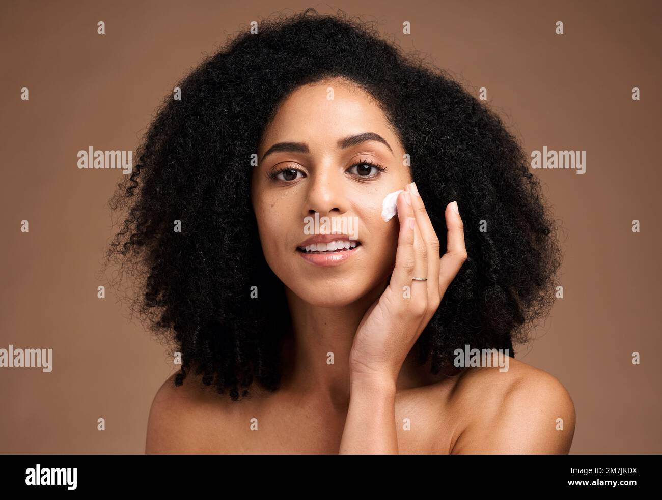 Face, cream and black woman in studio for skincare, beauty and ...