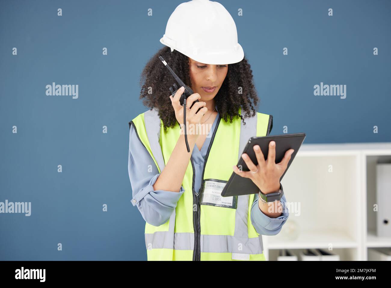 Radio, tablet and construction with a black woman builder talking over ...