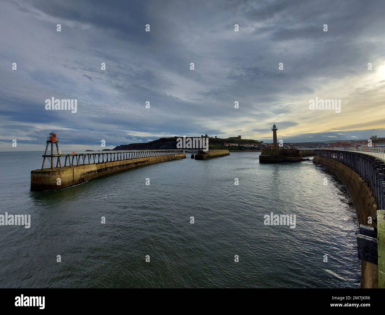 A scenic view of dramatic cloudy sky above the Whitby Lighthouse in ...