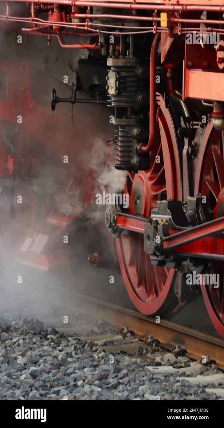 The train wheels covered with smoke on the railway Stock Photo - Alamy